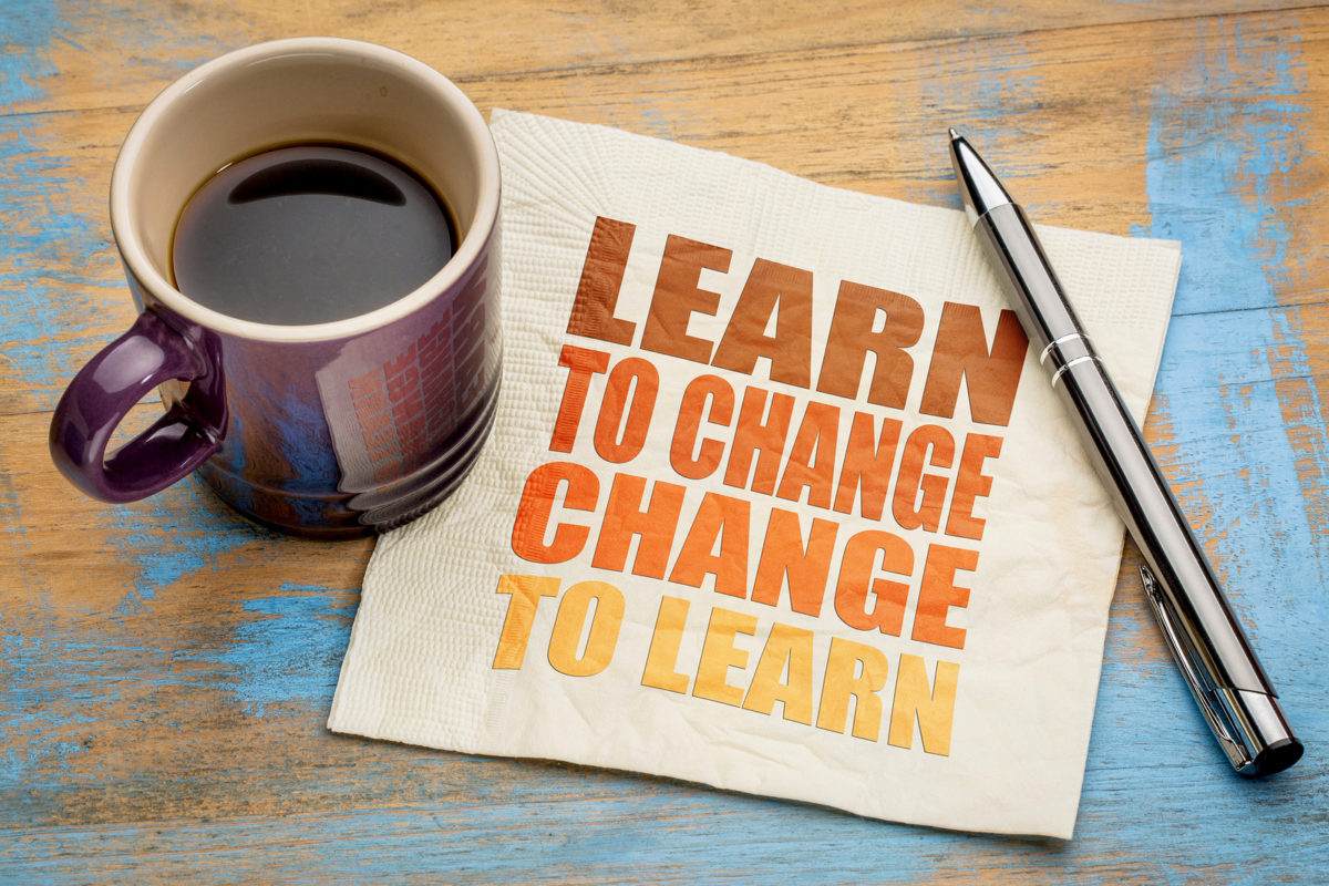 Learn to change, change to learn - word abstract on a napkin wi ...